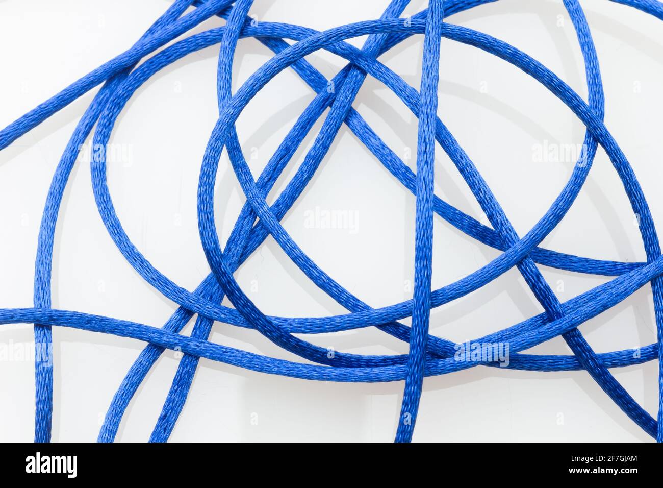 blue messy string, string out of coil a bit messy; blue string on white ...