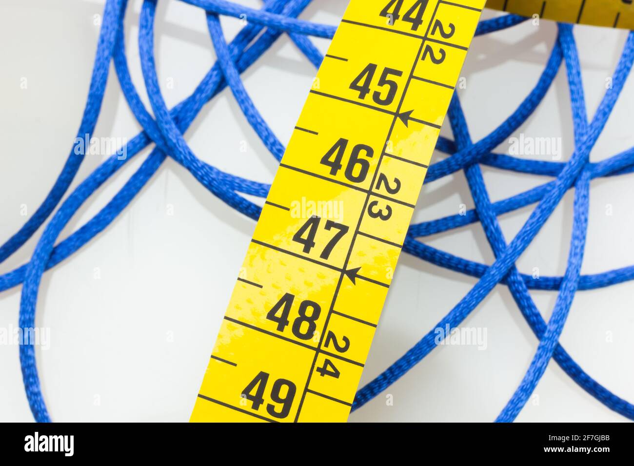 Portion of yellow tape measure on white background. Tape measure for ...