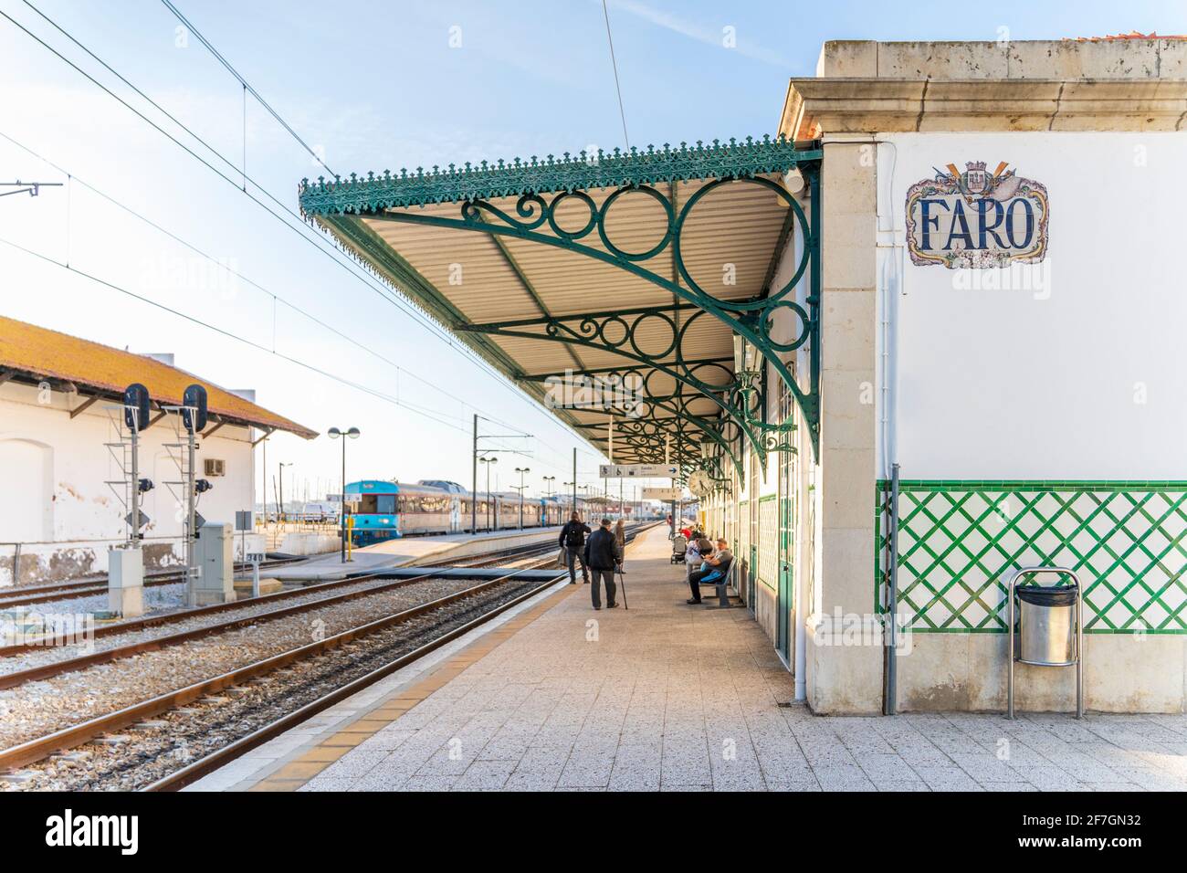 A few commuters waiting on train station in Faro, Algarve, Portugal ...