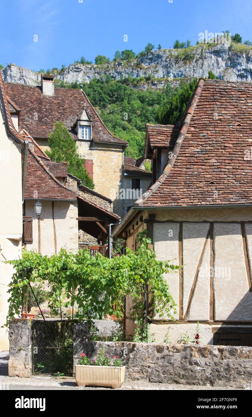 White limestone cliffs towering above the medieval village of Autoire, Lot ,France one of the ...