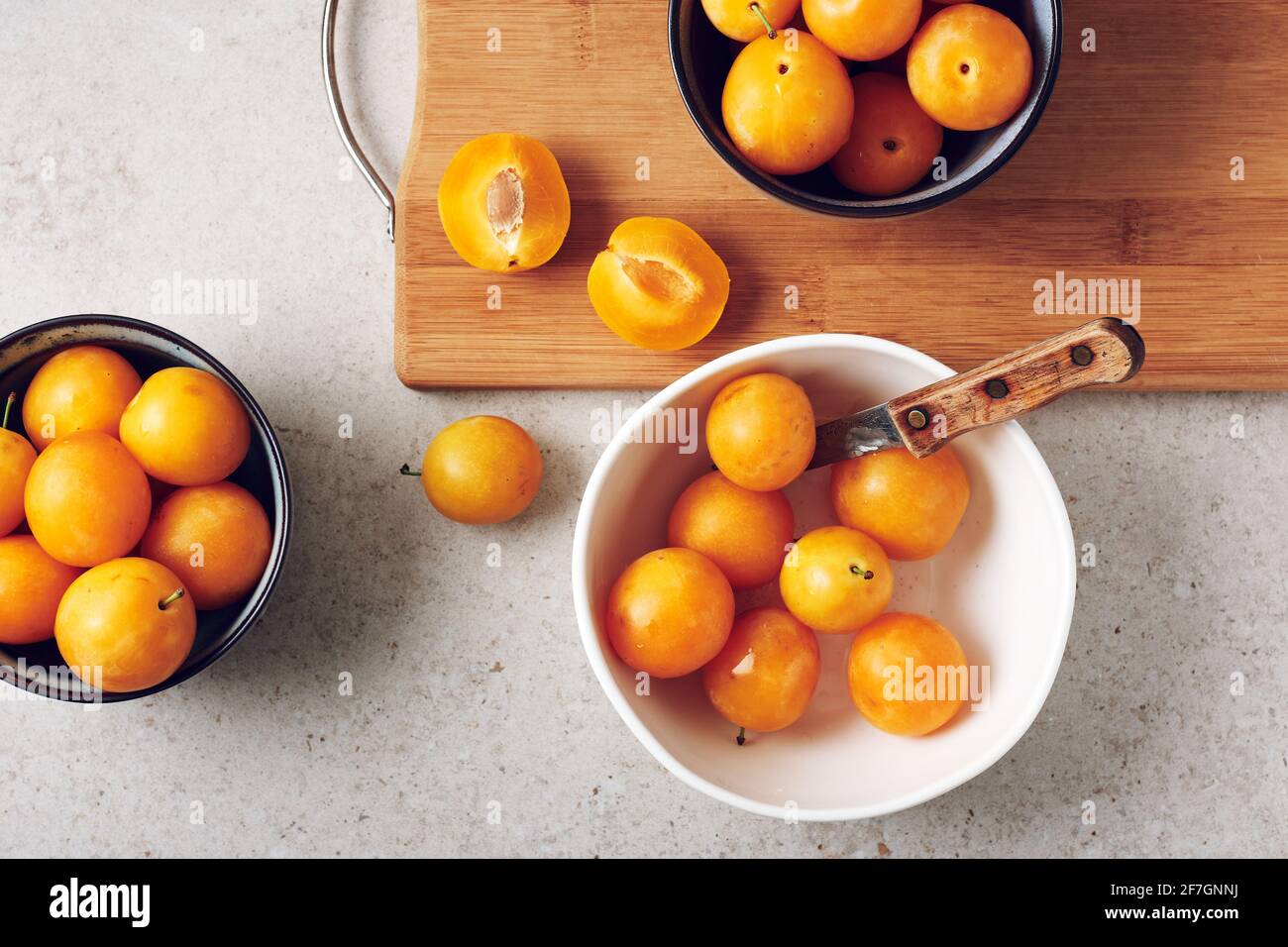 Ripe yellow mirabelle plums in bowls, top view Stock Photo - Alamy