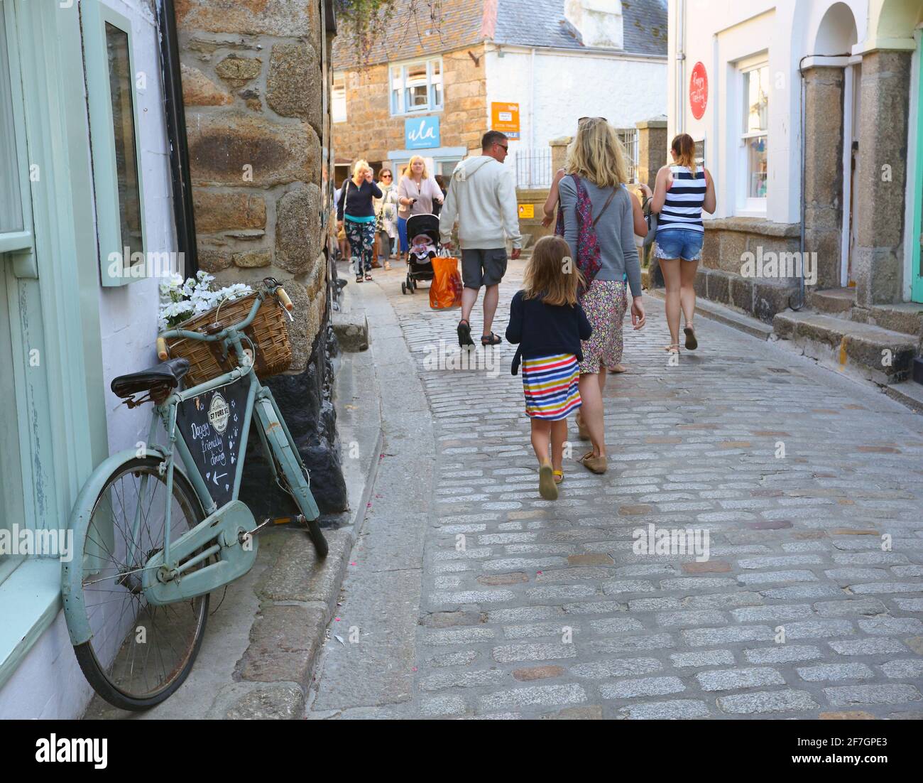 Shops on a cobbled street busy with tourists in St Ives, Cornwall ...