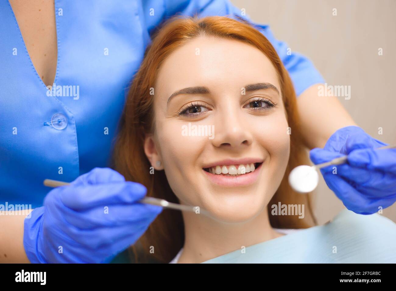 Dentist examining a patient's teeth in the dentist Stock Photo - Alamy