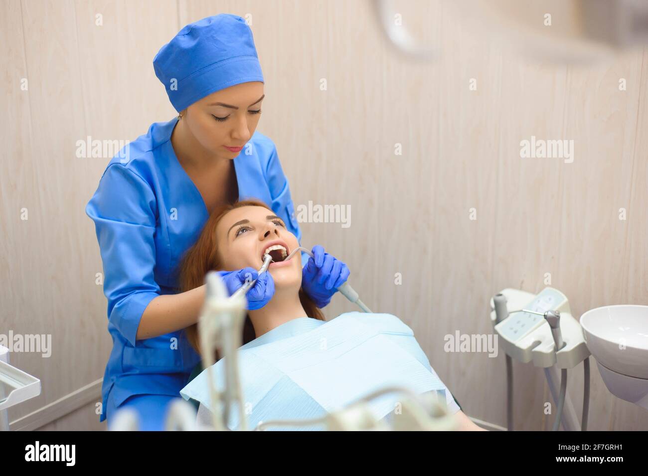 Dental inspection in clinic. Doctor in uniform checking up female ...