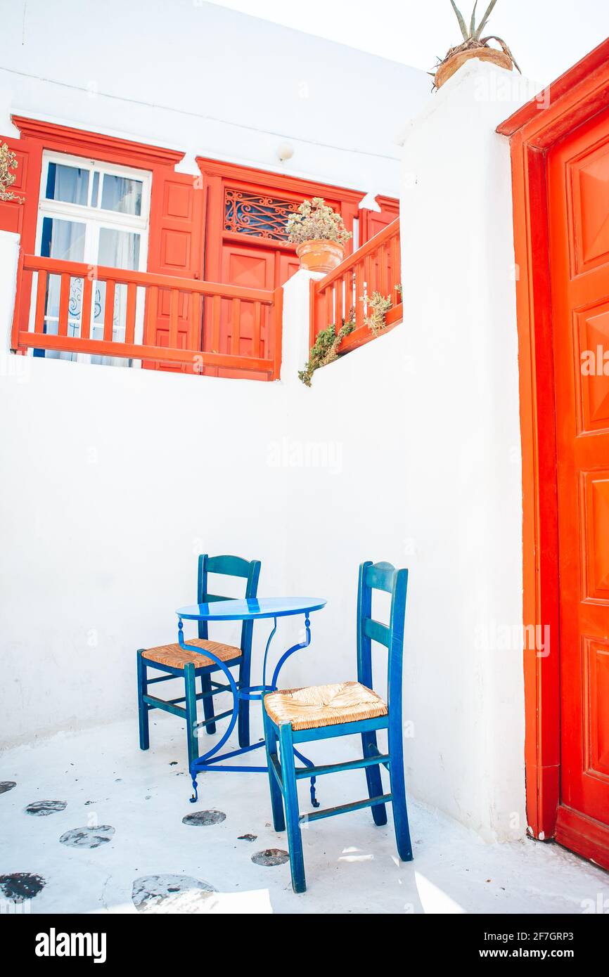 Cute cafe on the street of typical greek traditional village on Mykonos ...