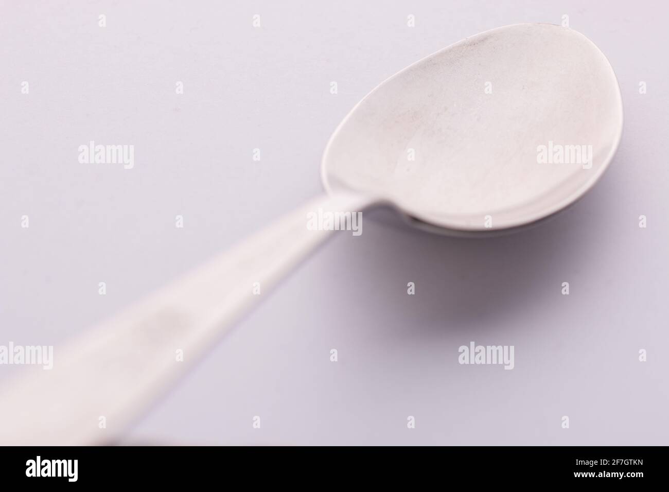 Single table spoon from different perspective on white Stock Photo - Alamy
