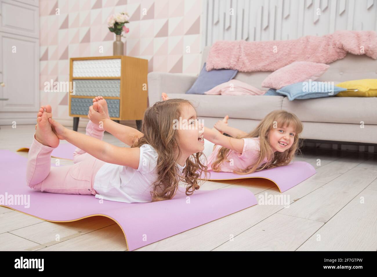 Full length front view smiling cute playful little preschool girls ...