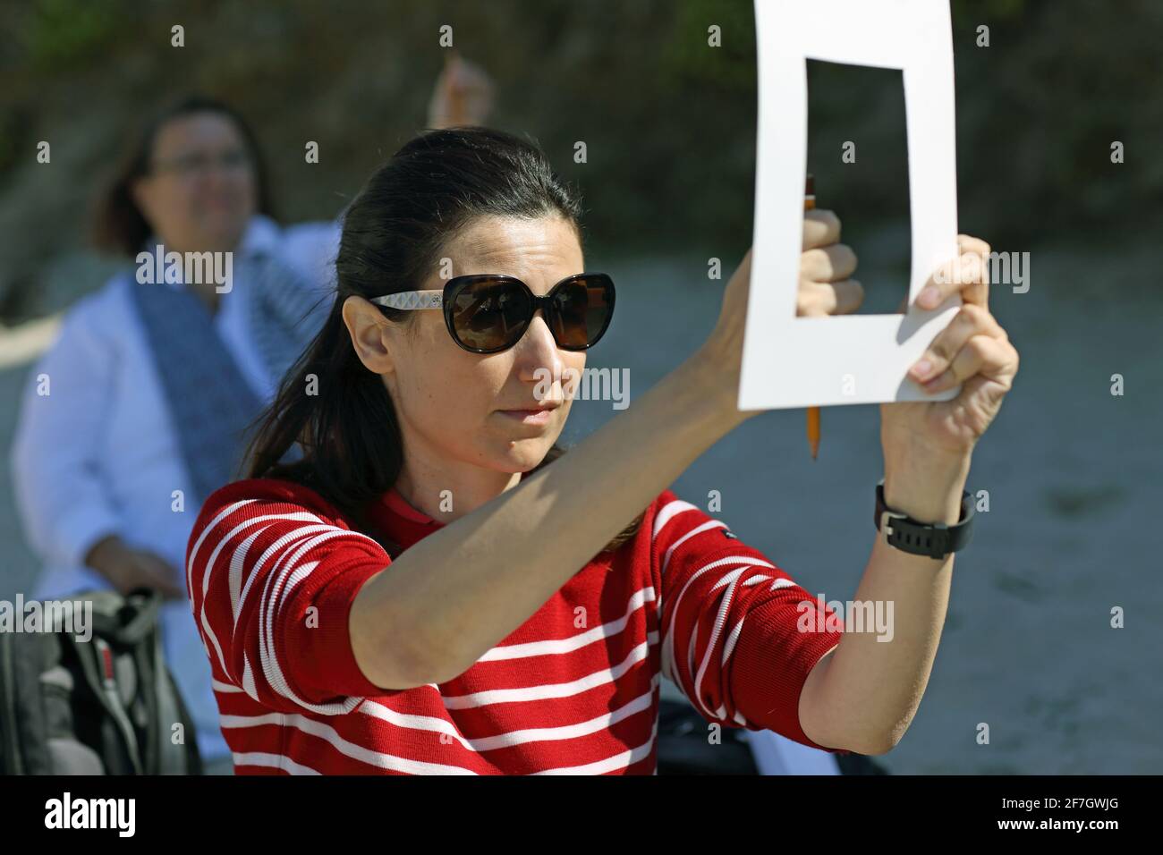 Female artists looking through frame during drawing classes in St Ives ...