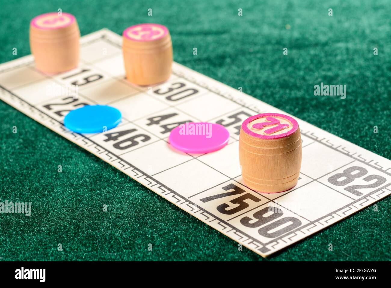 Lotto, a classic family board game. Three wooden barrels with numbers ...