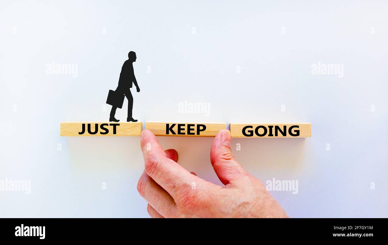 Just keep going symbol. Wooden blocks with words 'Just keep going ...
