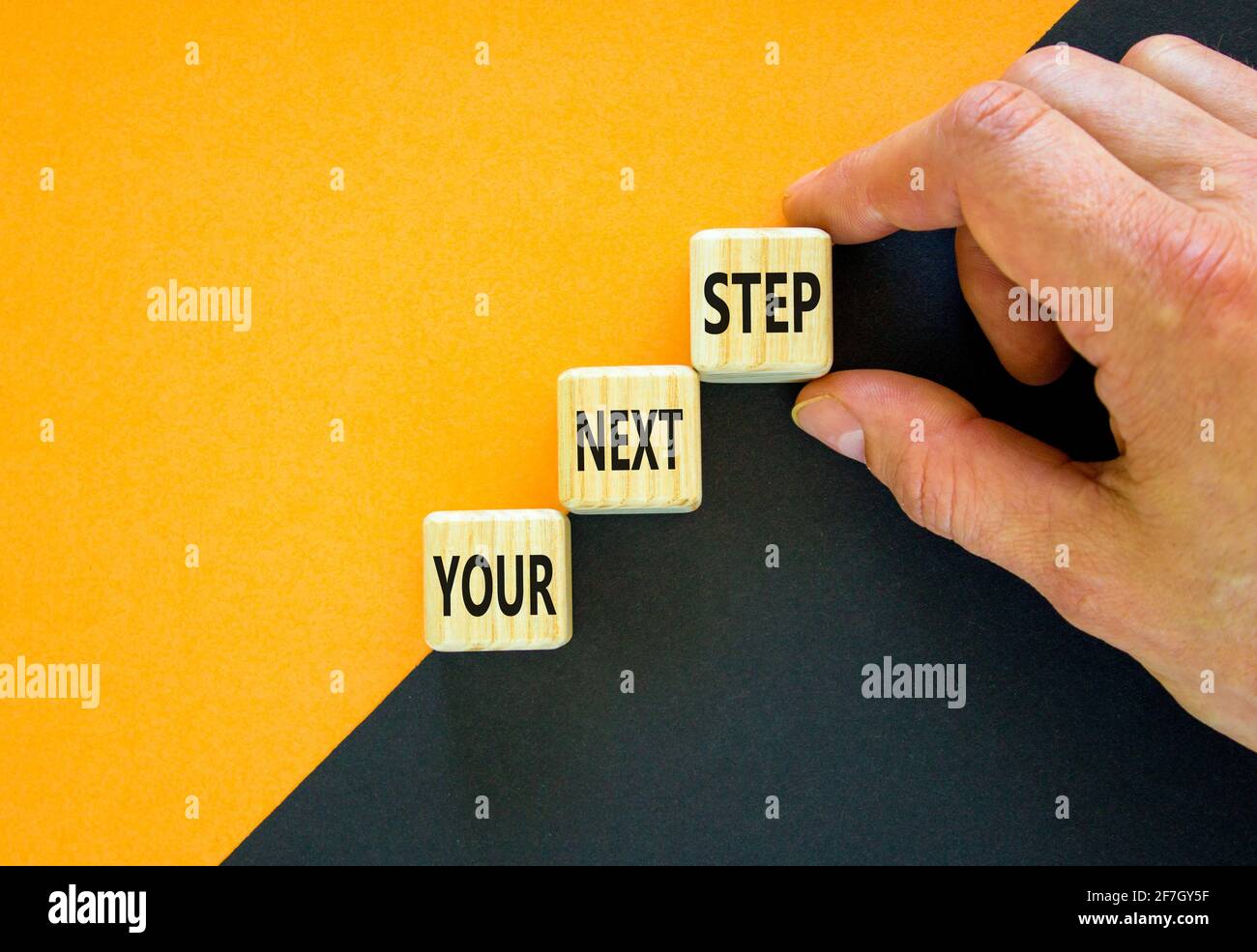 Your next step symbol. Hand arranging wood block stacking as step stair ...