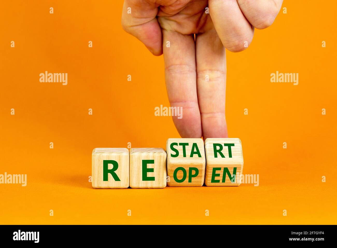 Reopen and restart symbol. Businessman hand turns cubes and changes the ...
