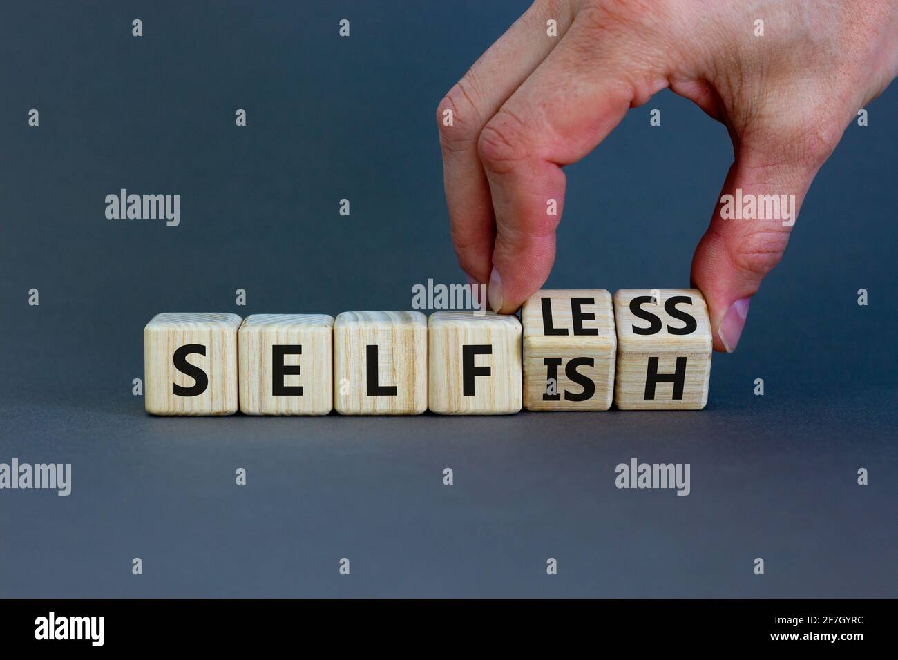 Selfish or selfless symbol. Businessman turns cubes and changes the ...
