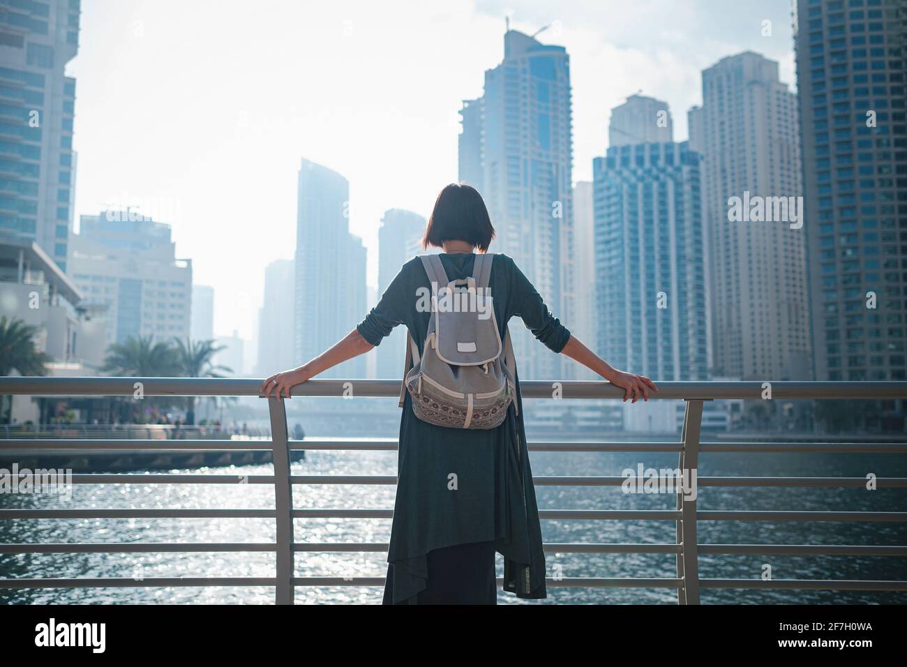 Happy young female traveler in the big city of Dubai, famous place ...