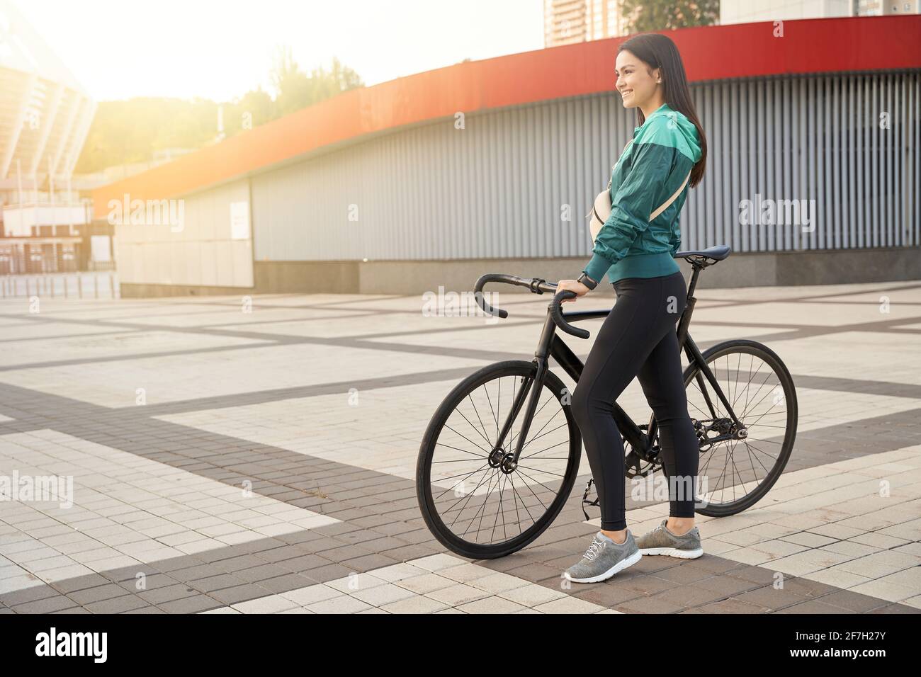 Smiling beautiful female going for bike ride in the city Stock Photo ...