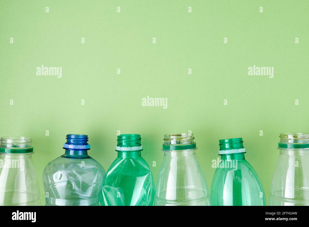 flat lay with plastic bottles isolated on green Stock Photo - Alamy