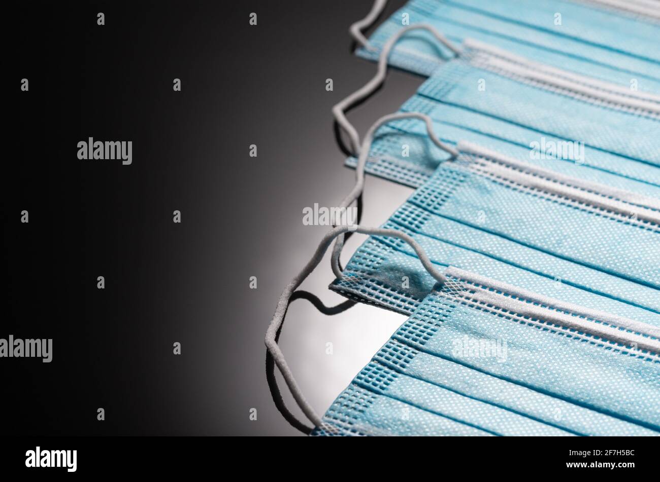 Surgical masks with rubber ear straps. A typical three-layer surgical ...