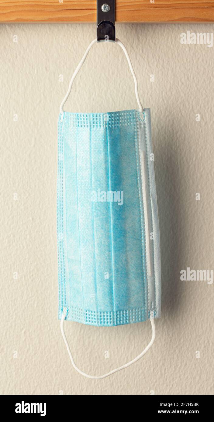Surgical mask with rubber ear straps. A typical three-layer surgical ...