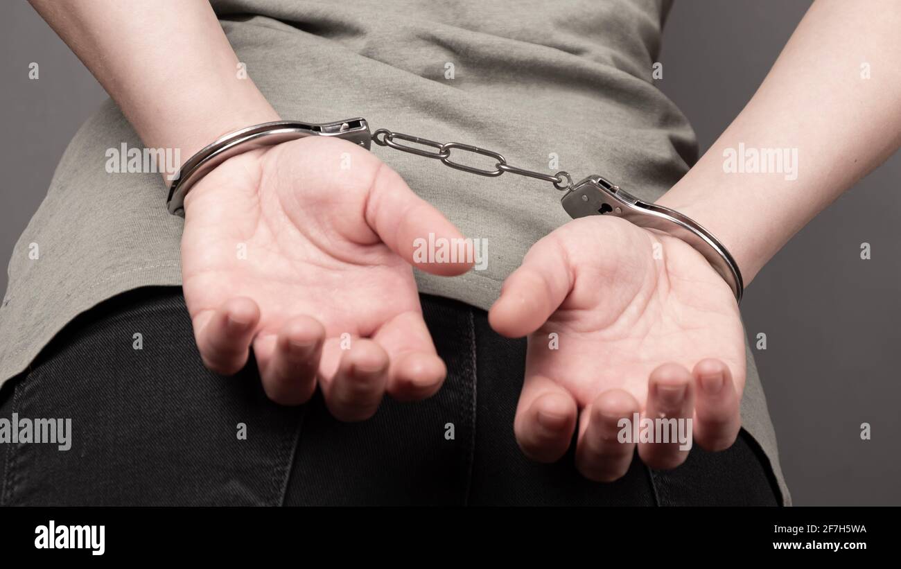 prisoner in handcuffs, arrested terrorist, hands are handcuffed, close ...
