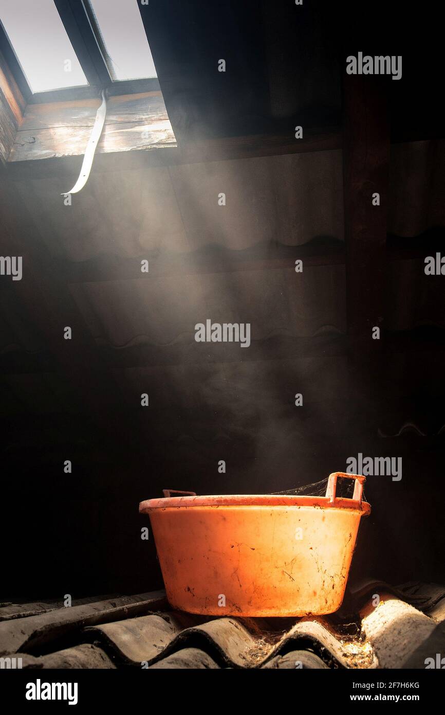 Old worn red bucket standing in a foggy environment on the attic. Red ...