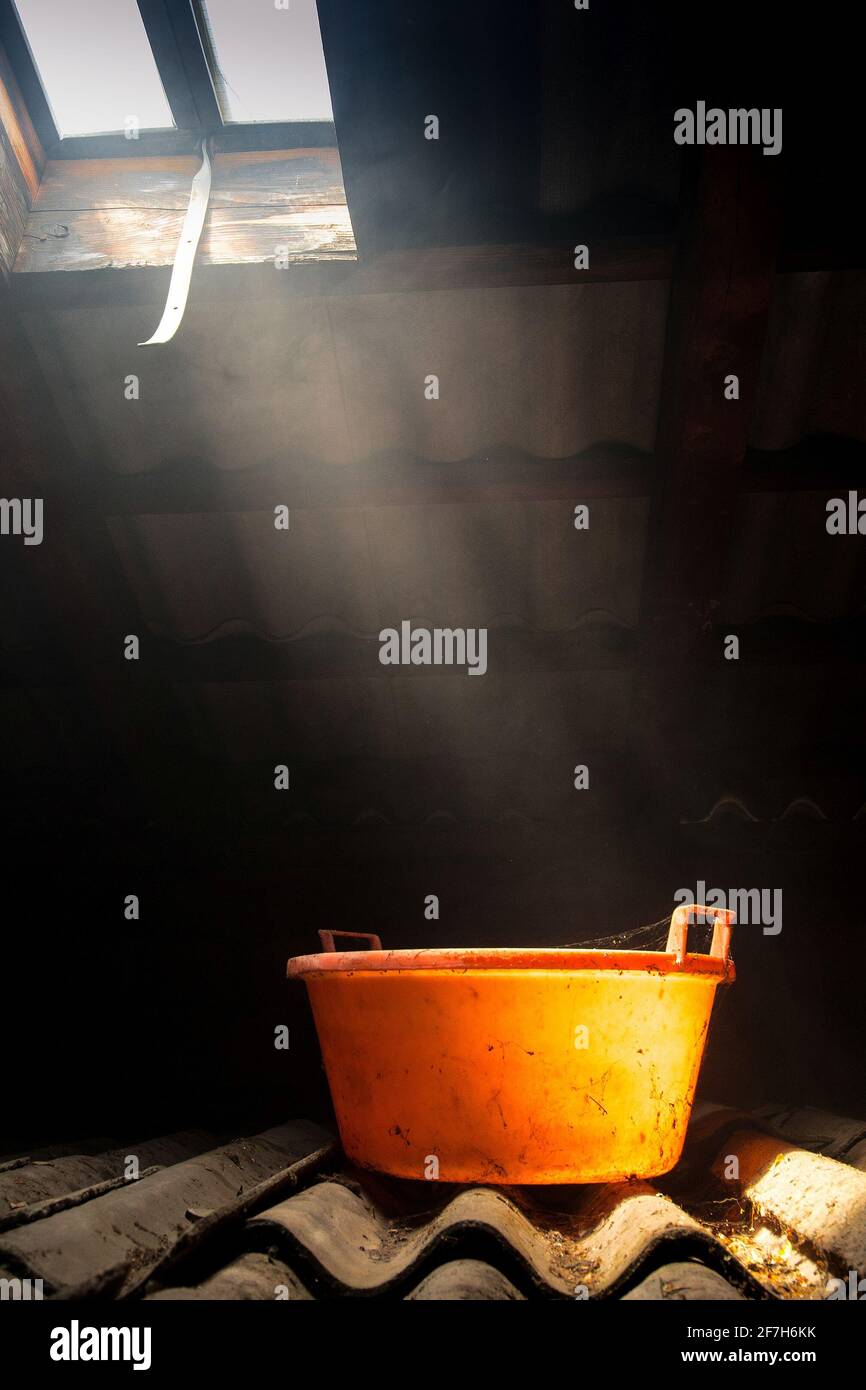 Old worn red bucket standing in a foggy environment on the attic. Red ...