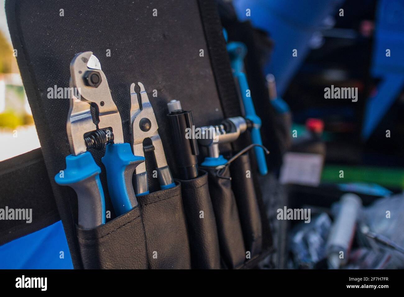 An assortment of modern blue coloured bicycle tools in a tool box or ...