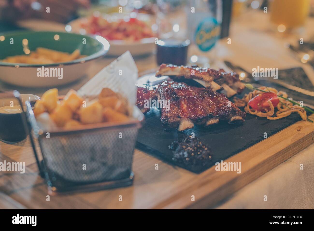 Delicious fresh spare ribs in a restaurant, served on a fancy black ...