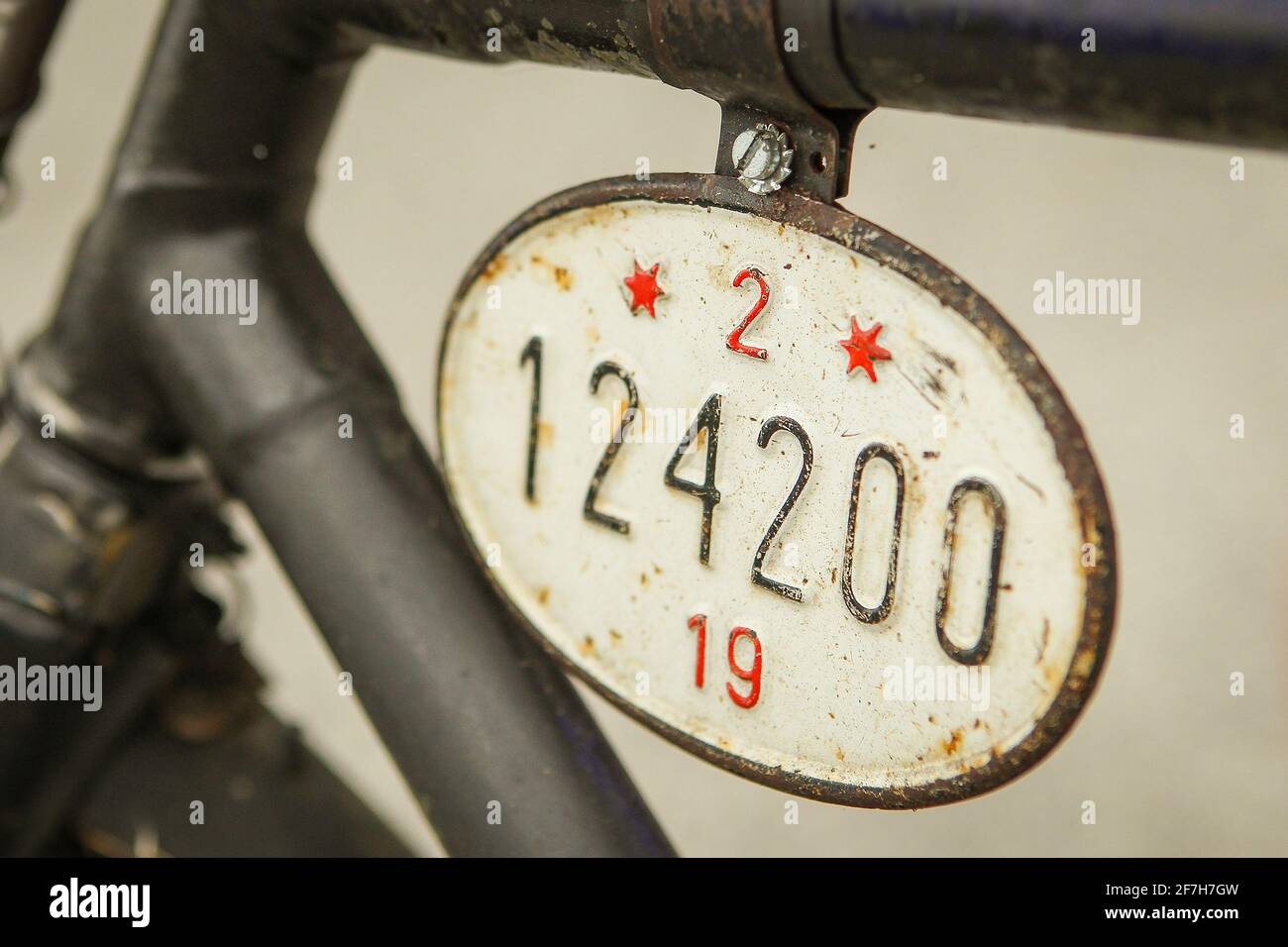 War time round registration plate with numbers and stars on an old ...