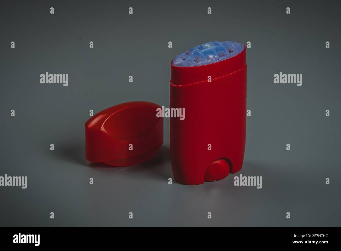 Empty red deodorant stick with open top on a gray background. Visible ...
