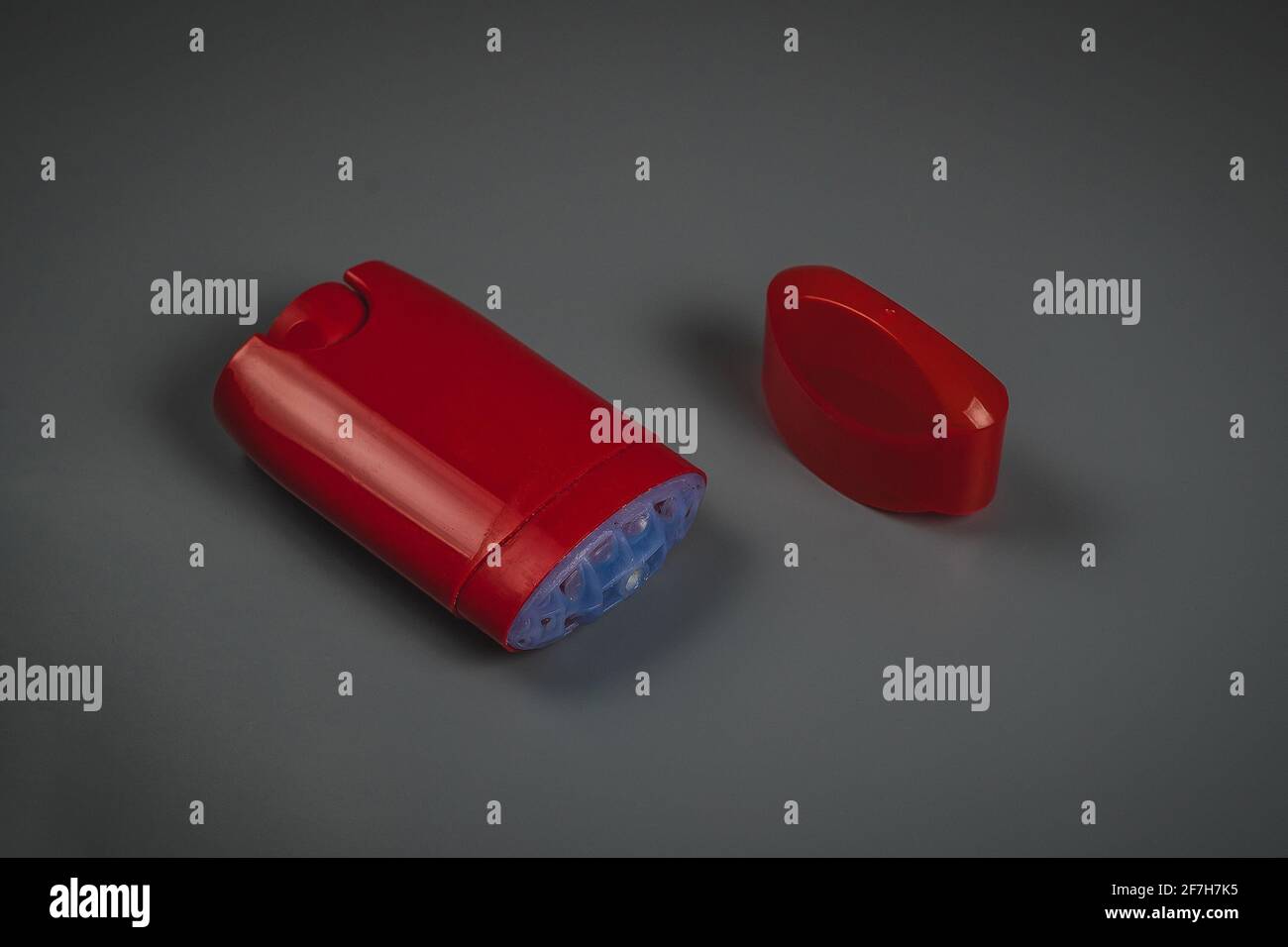 Empty red deodorant stick with open top on a gray background. Visible ...