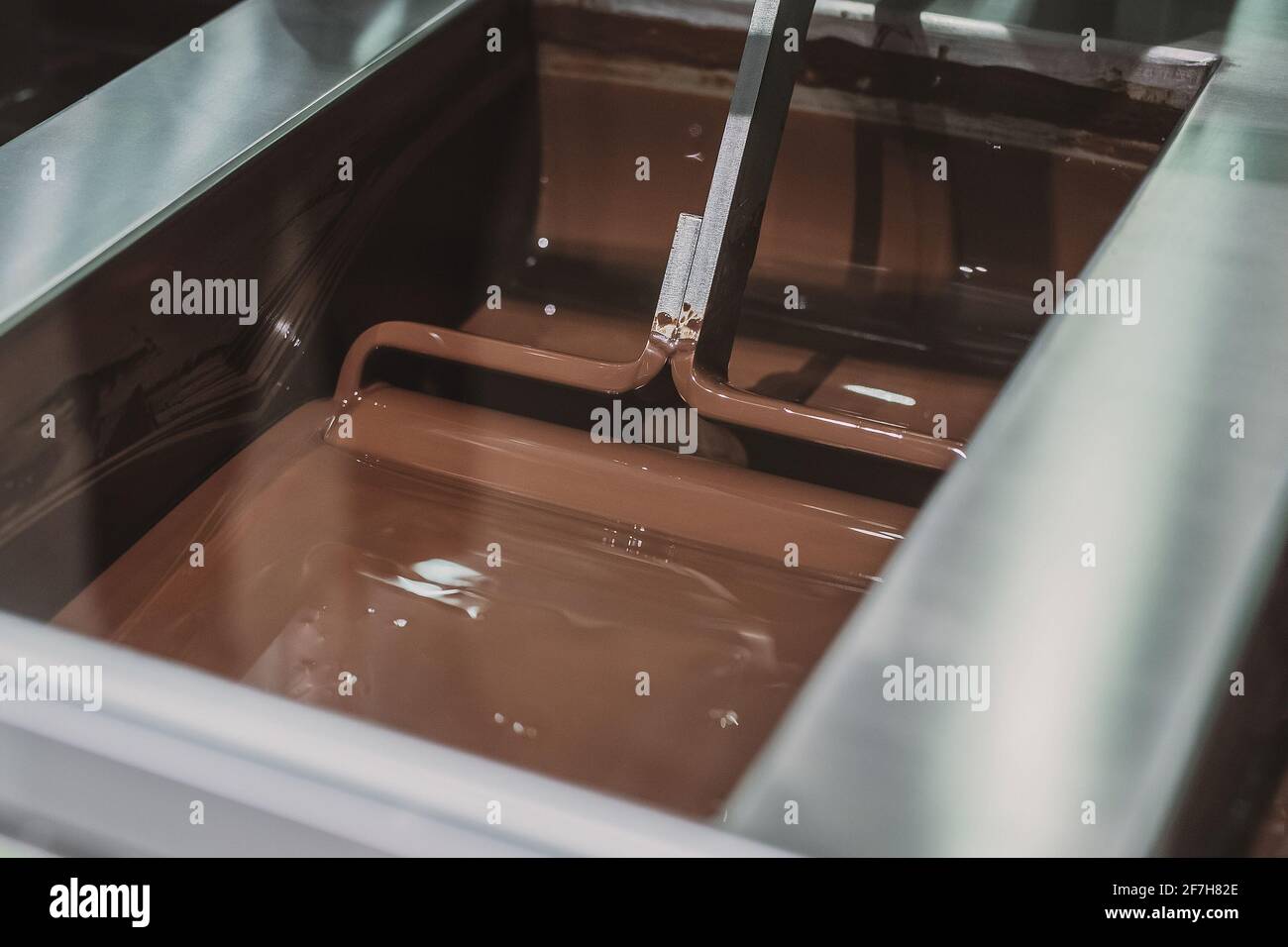 Industrial stirring of chocolate. Machines in chocolate factory stir ...