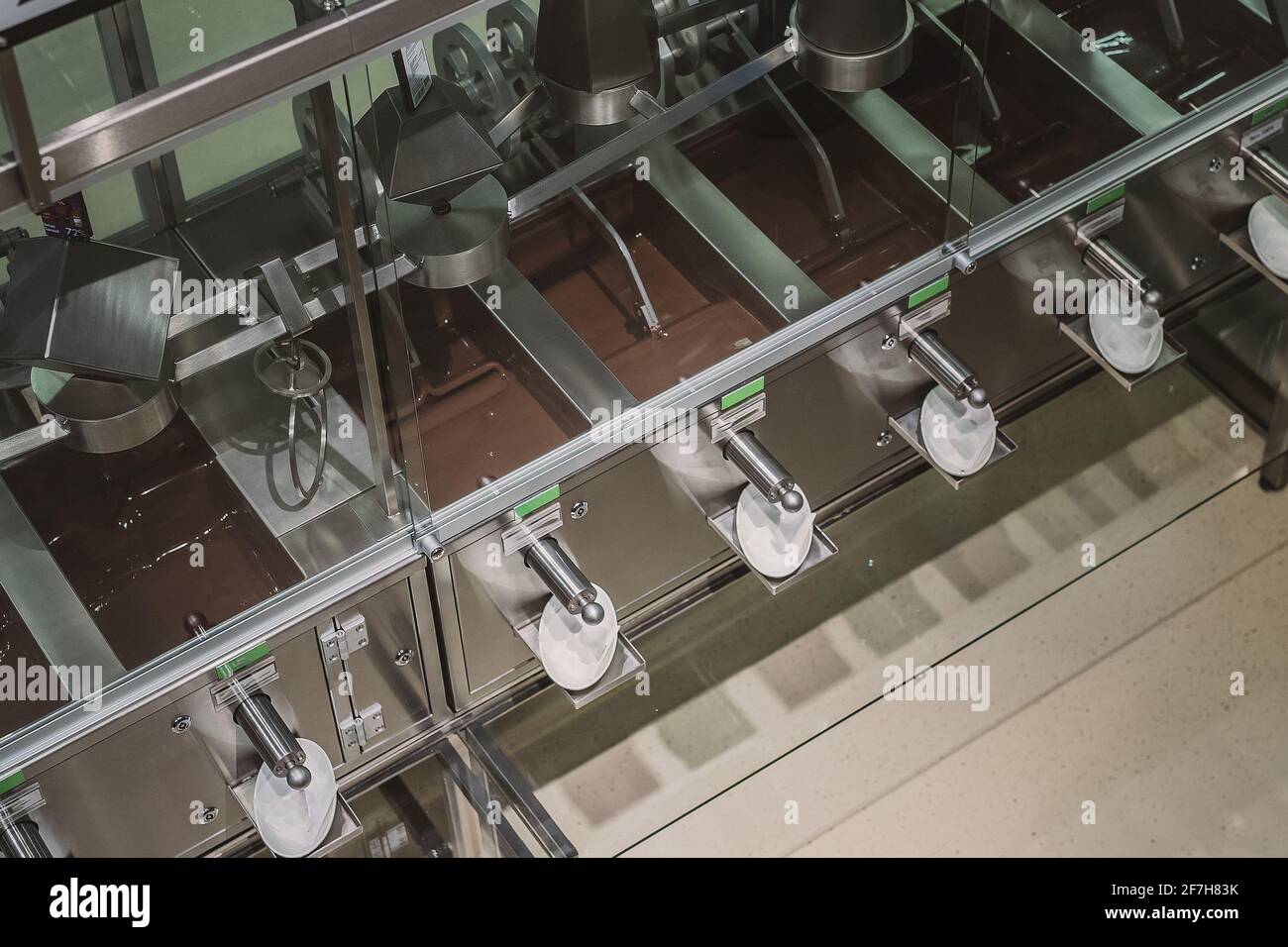 Industrial stirring of chocolate. Machines in chocolate factory stir ...