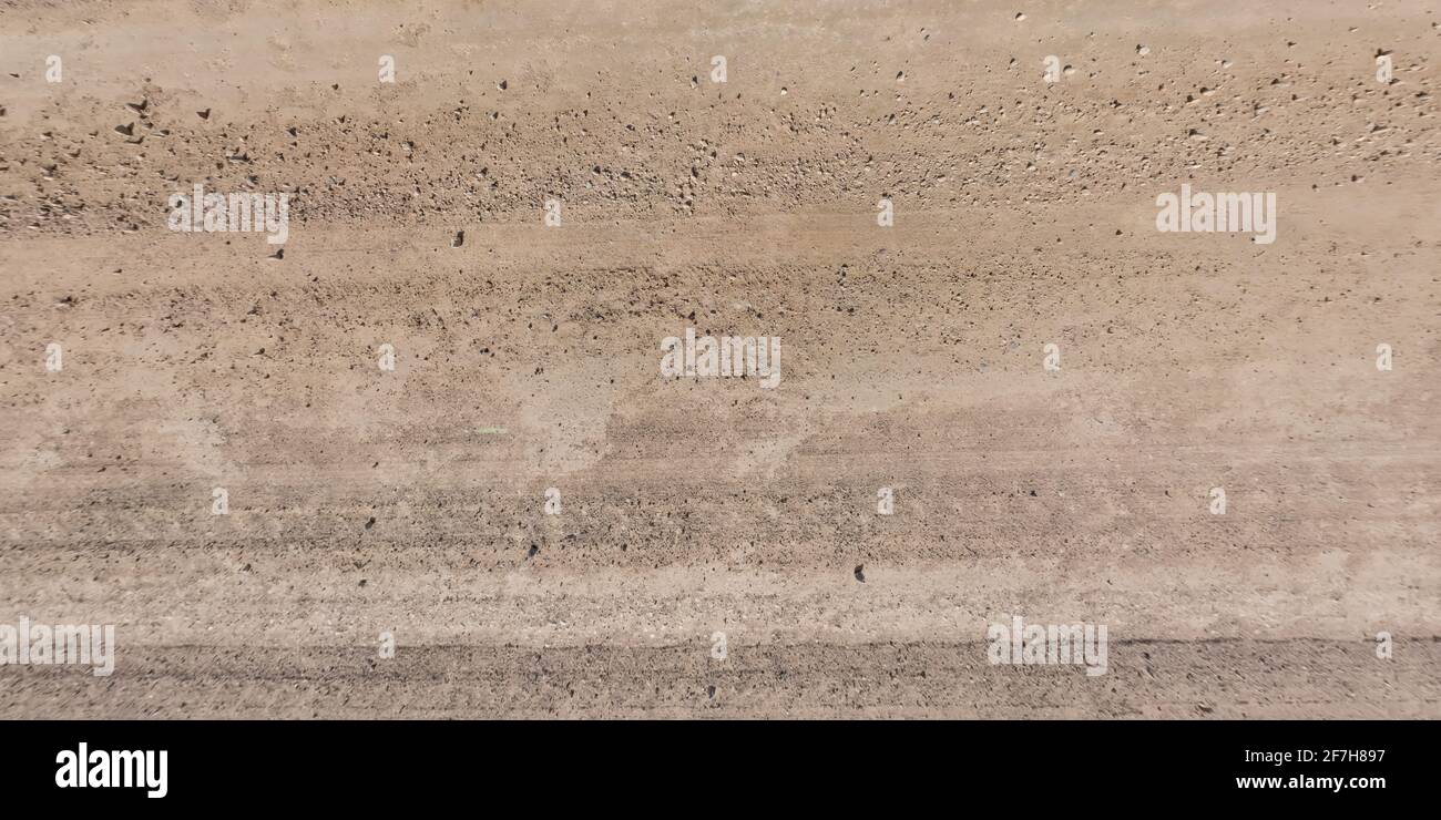 view from above on car tire tracks on texture of gravel road Stock ...
