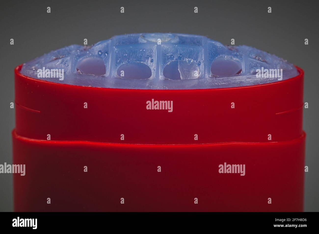 Empty red deodorant stick with open top on a gray background. Visible ...