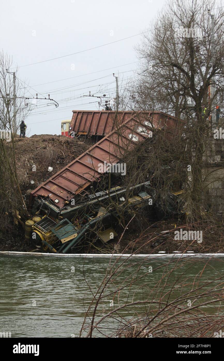 Closeup of a train wreck. The train drove from a bank into the river ...