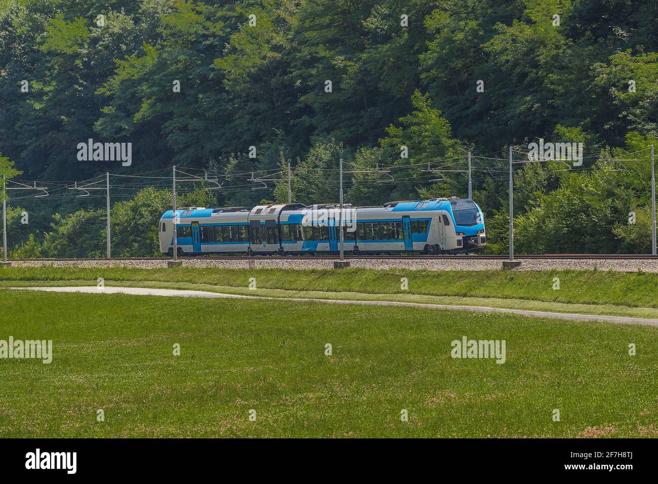 Modern and new passenger swiss made Train in white and blue color is ...