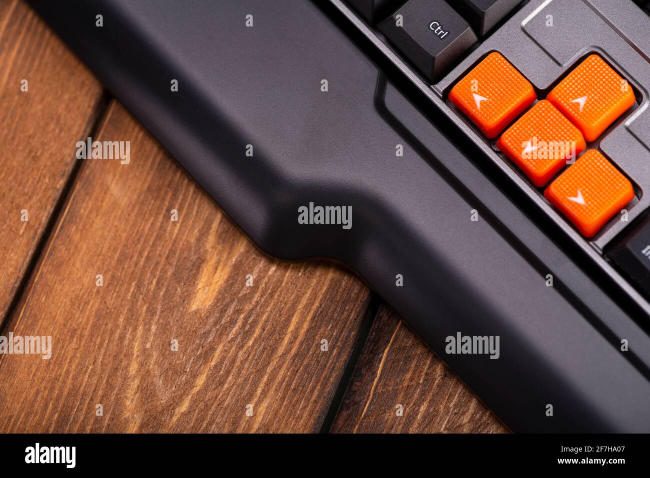Orange arrow keys on a black keyboard, up, down, left, right buttons on ...