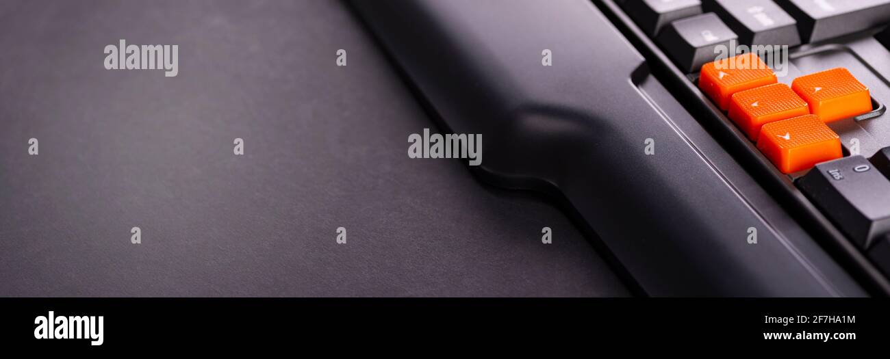 Orange arrow keys on a black keyboard, up, down, left, right buttons on ...