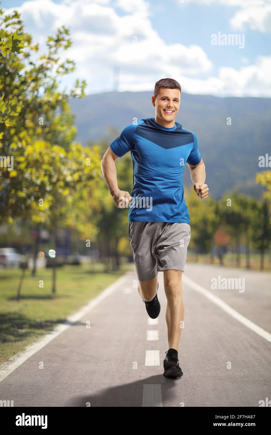 Young guy running on asphalt hi-res stock photography and images - Alamy