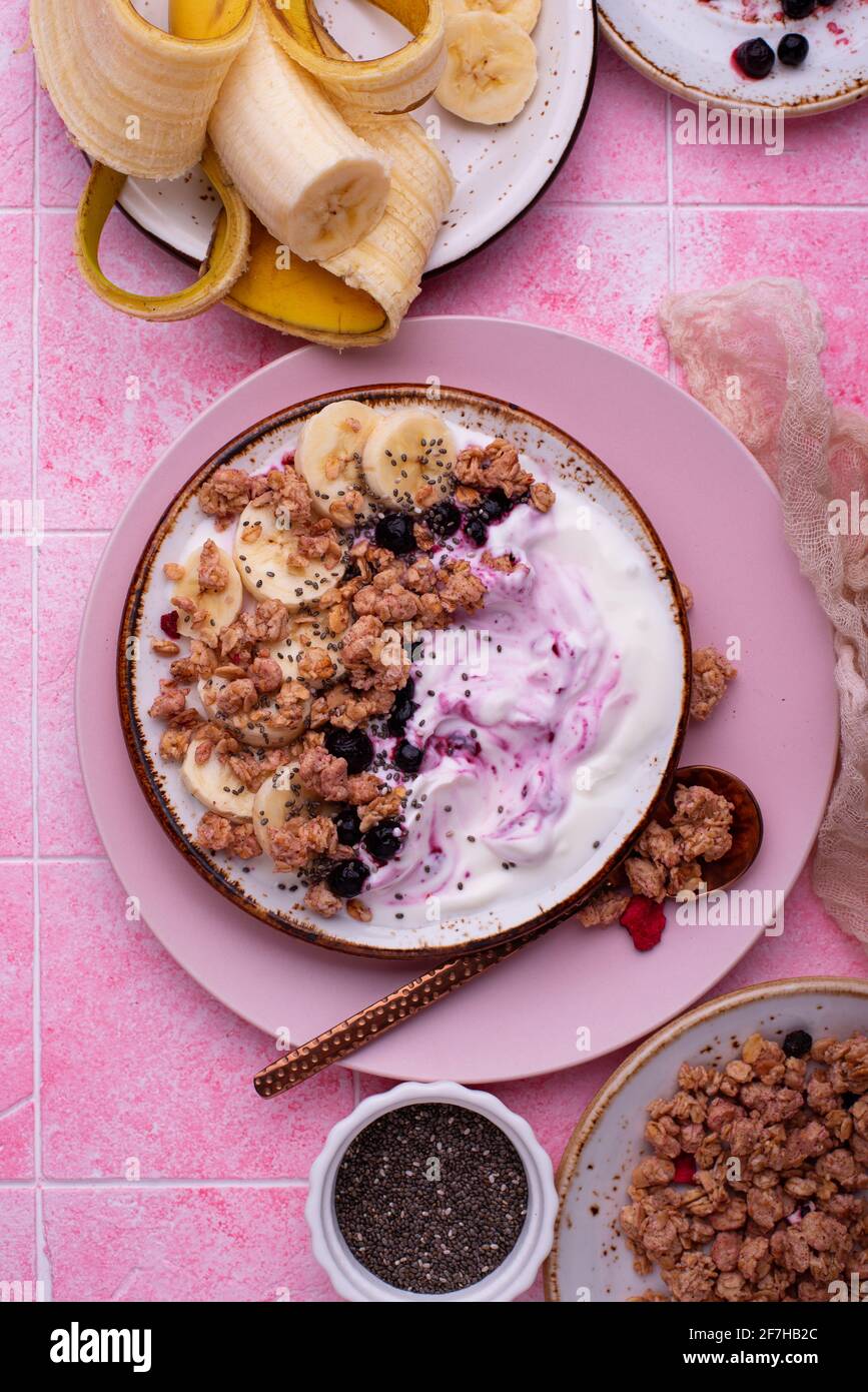 Granola on pink tile background Stock Photo - Alamy