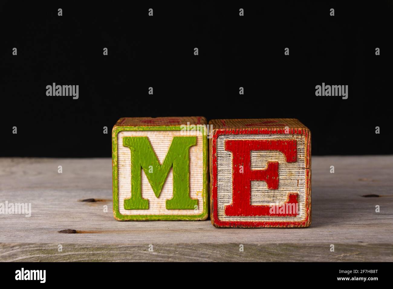 The word me spelled in vintage wooden blocks and black background Stock ...