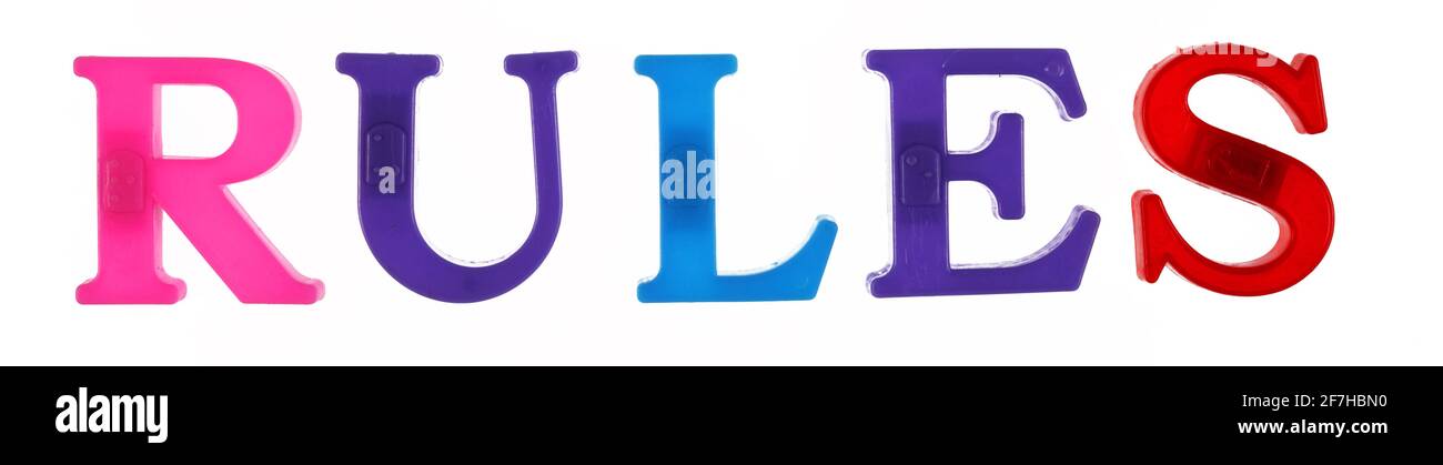 The word rules is lined with multicolored plastic letters isolated on ...