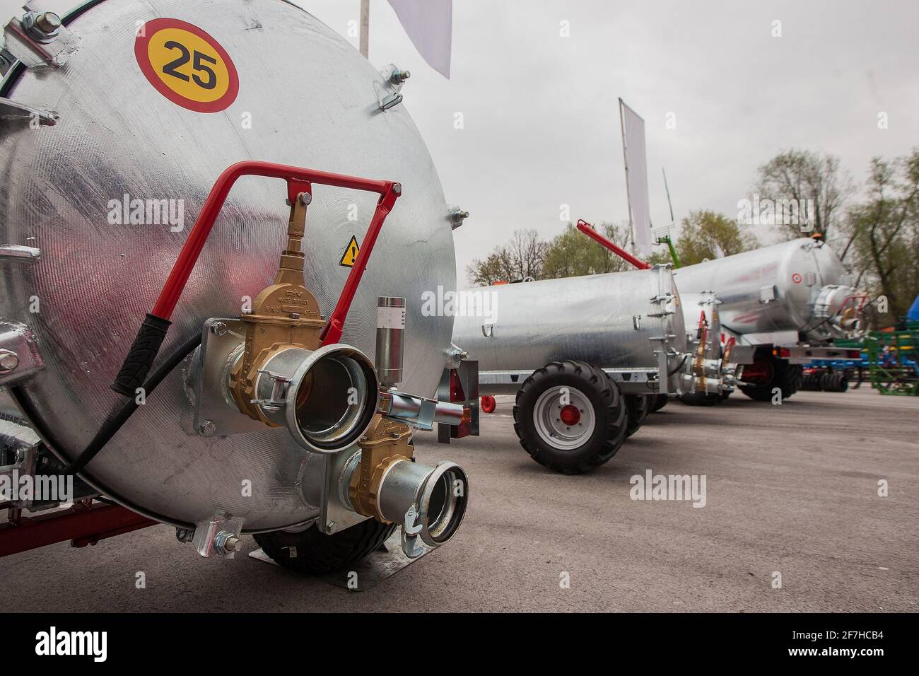 Scene from a farm business fair, showing a collection of manure tankers ...