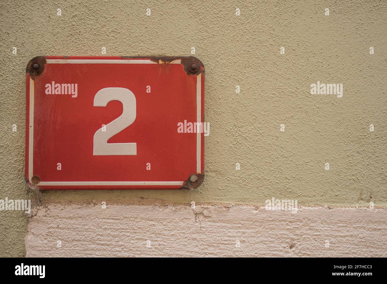 House number two, white letter two or 2 on a red metal plate background ...