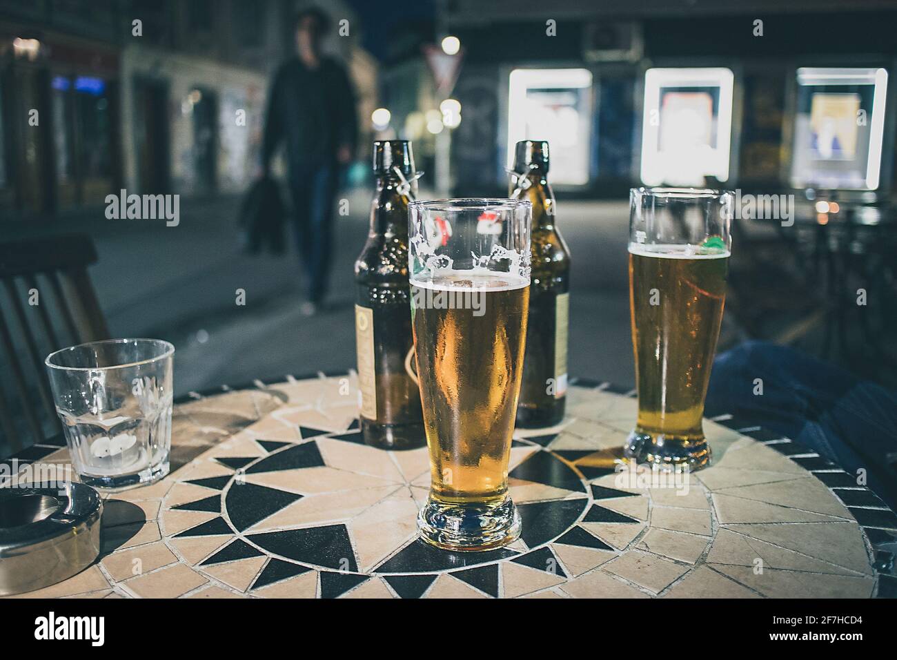 Two lager beers in half litre glasses on a bar table outdoor during ...