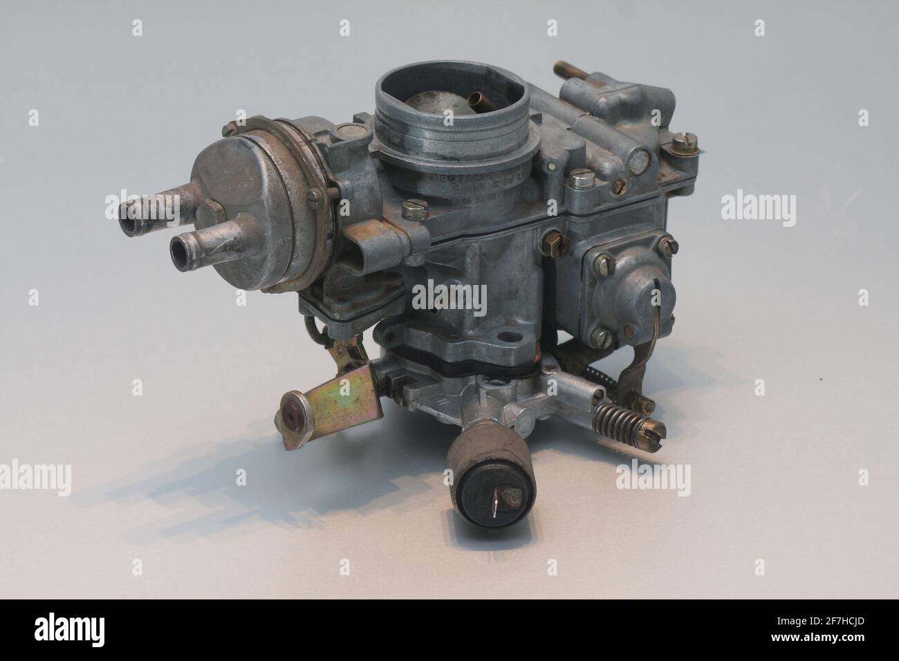 An old and used automotive carburettor isolated on white. Automatic ...