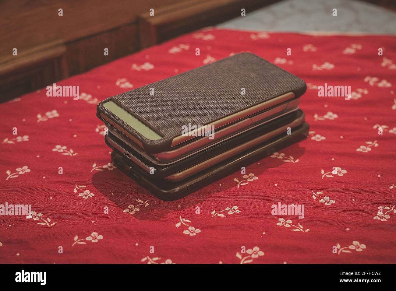 Game of stacking the telephones on one each other. Mobile phones one on ...