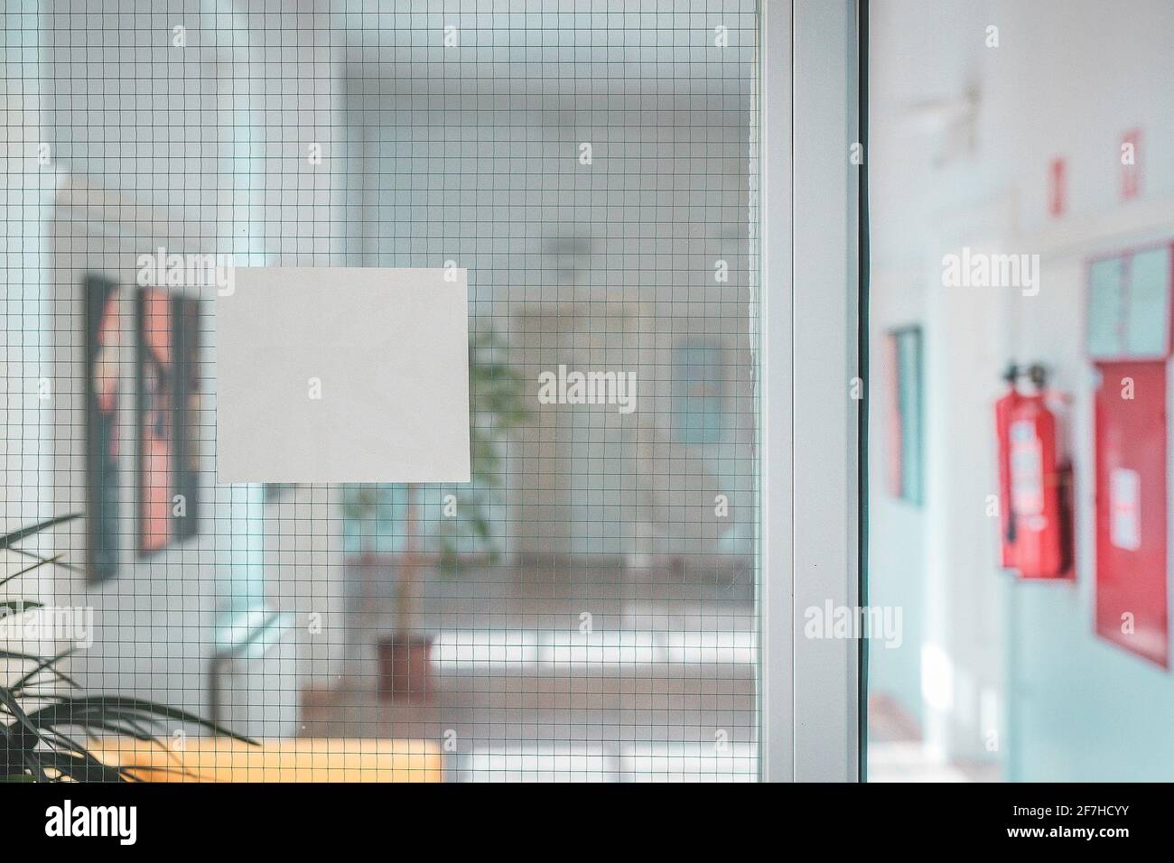 Plain white A4 paper on the door with metal safety net in a white ...
