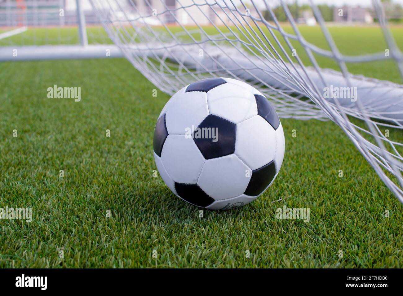 Soccer ball in the net on the lawn Stock Photo - Alamy