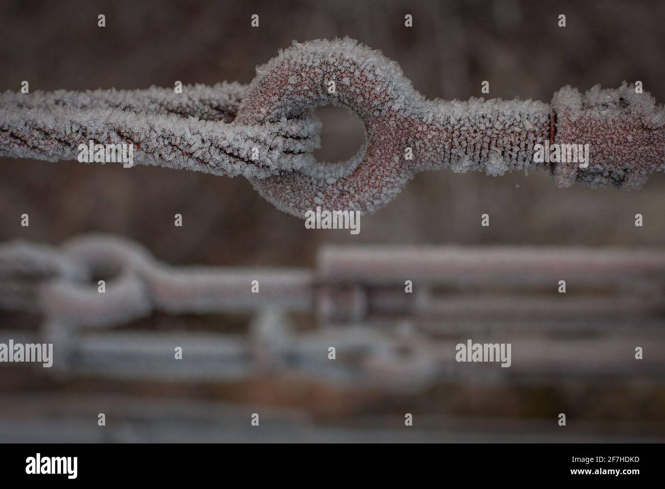 Thick rope covered in frost passing through an iron hook Stock Photo ...